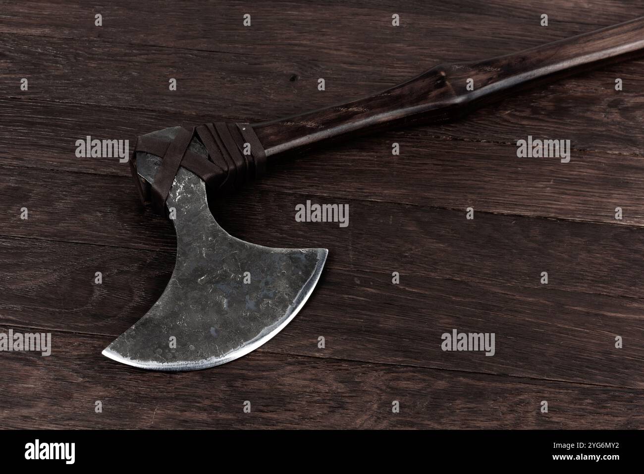 antique battle axe with long wooden handle on wood background Stock ...