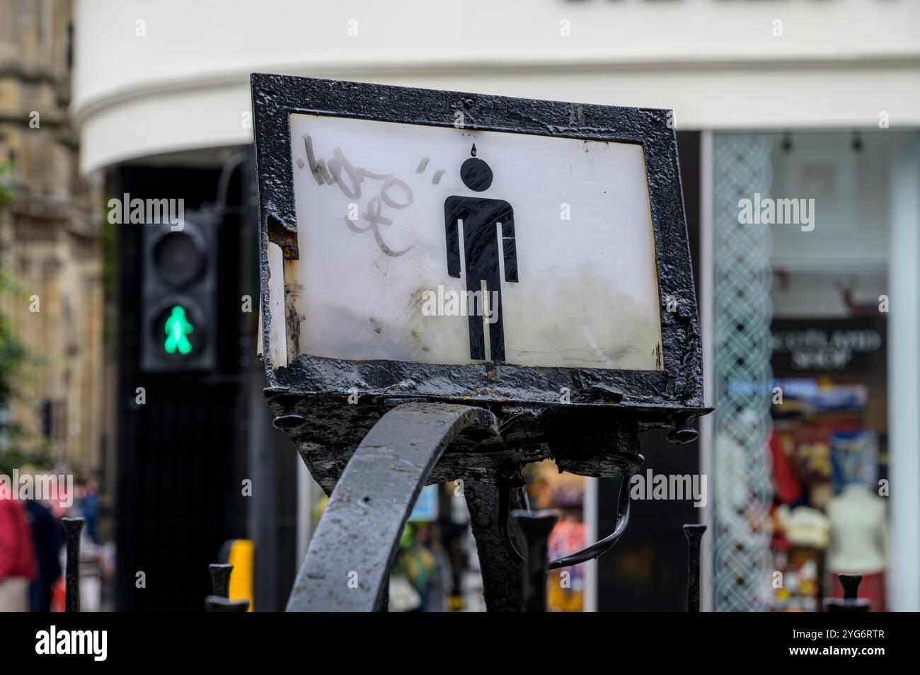 Green man beside a male public toilet sign Stock Photo - Alamy