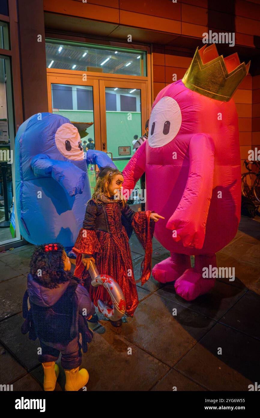 2 young girls and people in Spirit Halloween Inflatable character ...