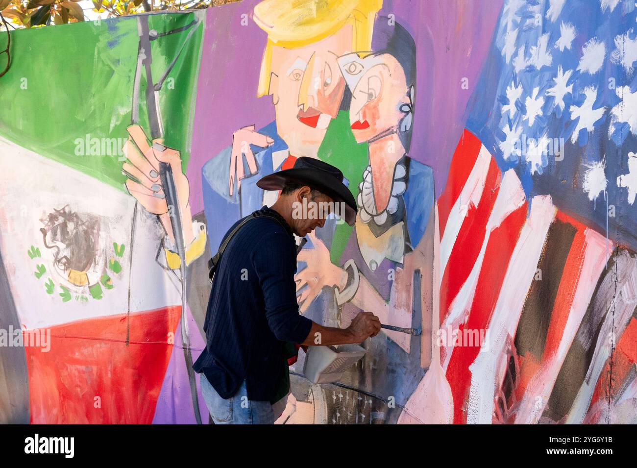 Roberto Marquez, of Dallas, works on his painting of President-elect ...