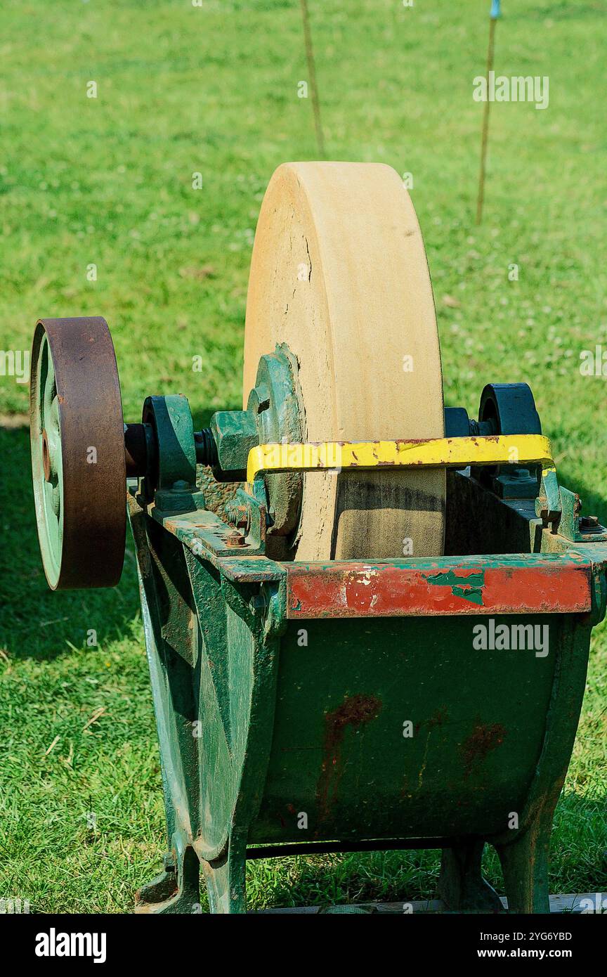 An old belt-driven knife sharpener grinding wheel on display at a ...