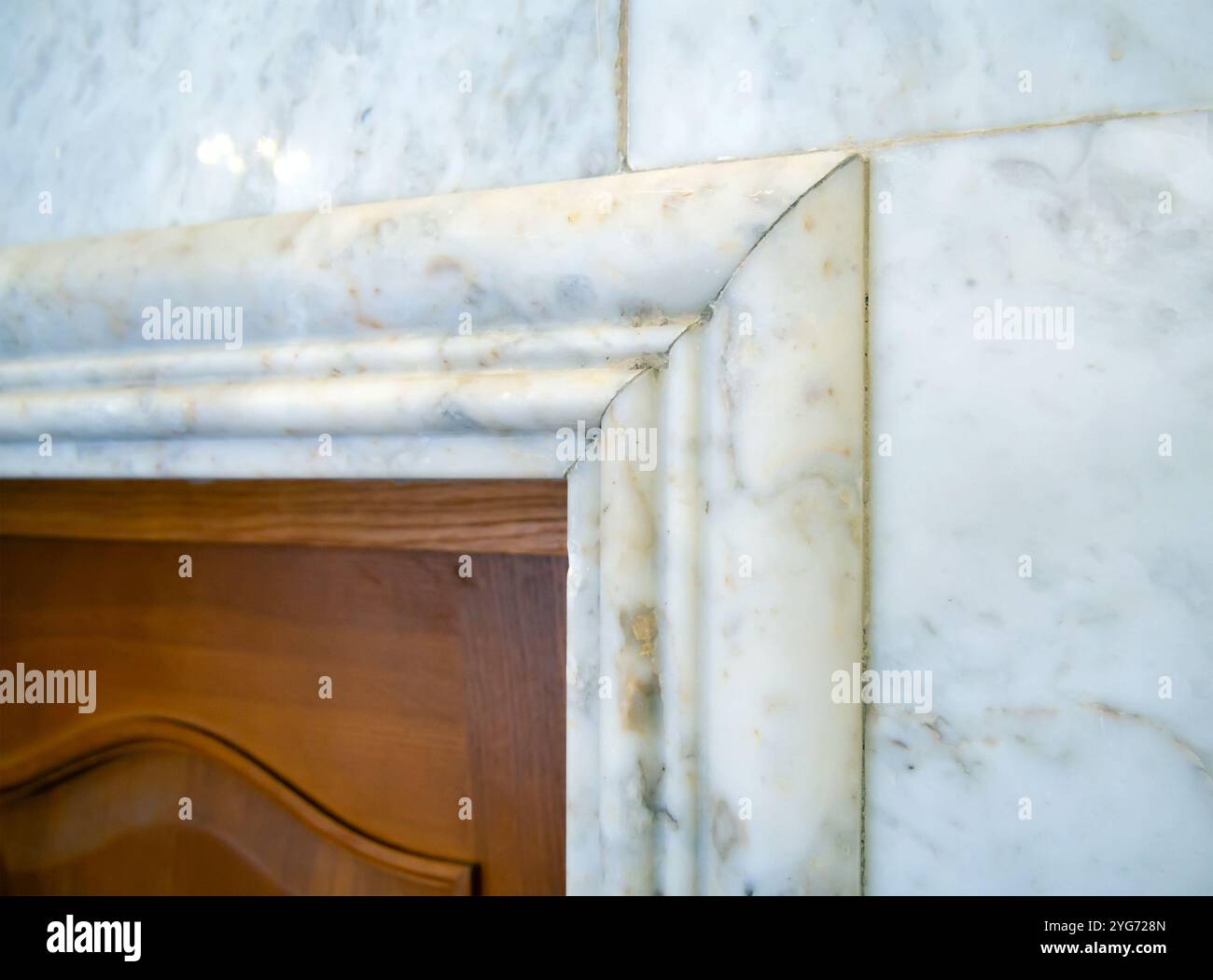 Decorating a door made of valuable wood with marble trim Stock Photo ...