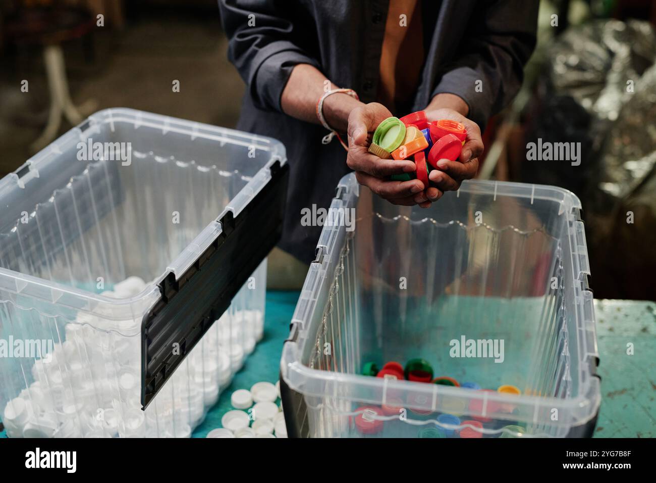 Hands of unrecognizable male worker of plastic recycling factory ...