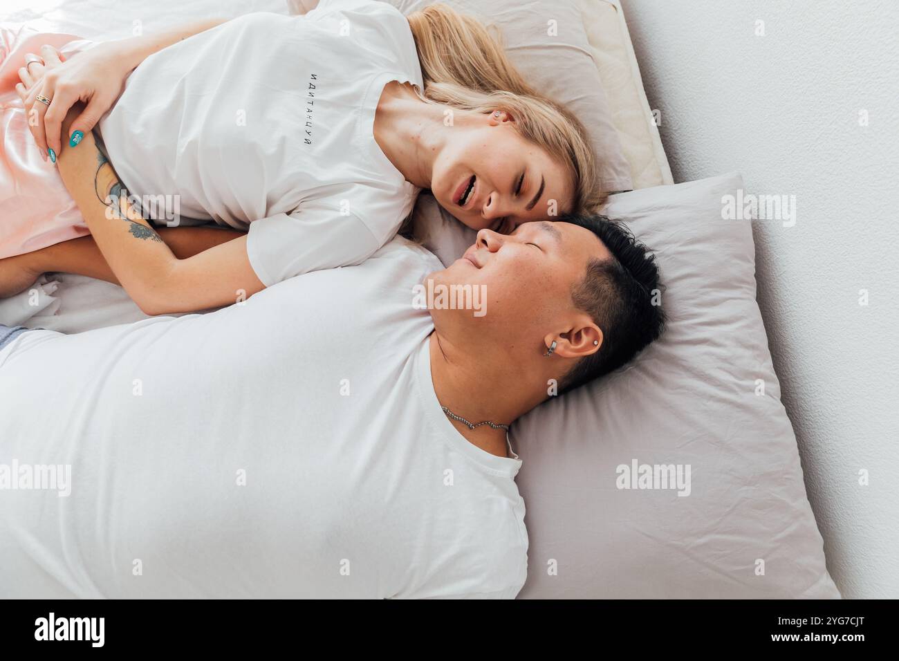 Man and woman sleeping by side in bedroom on bed Stock Photo - Alamy