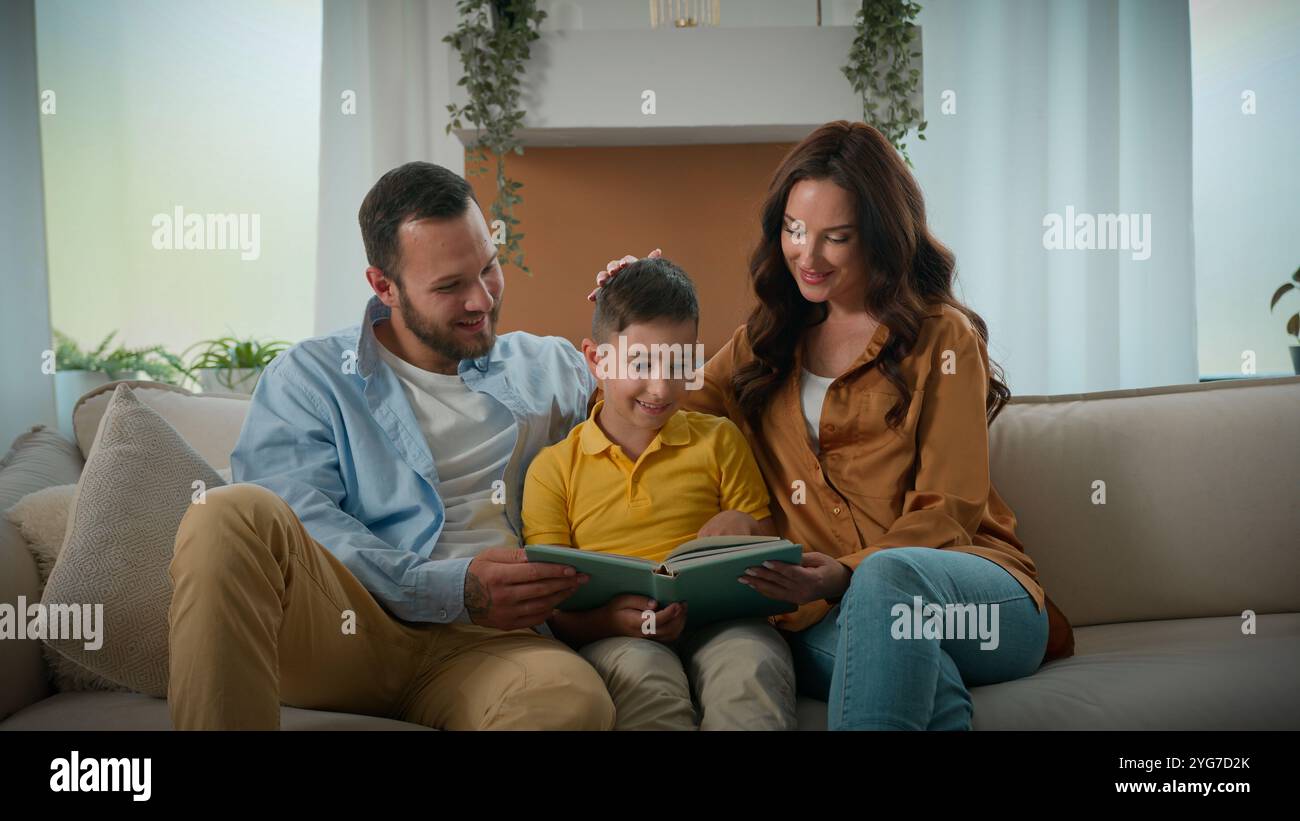 Loving caring mom dad reading fairy tale story to cute son parents kid ...