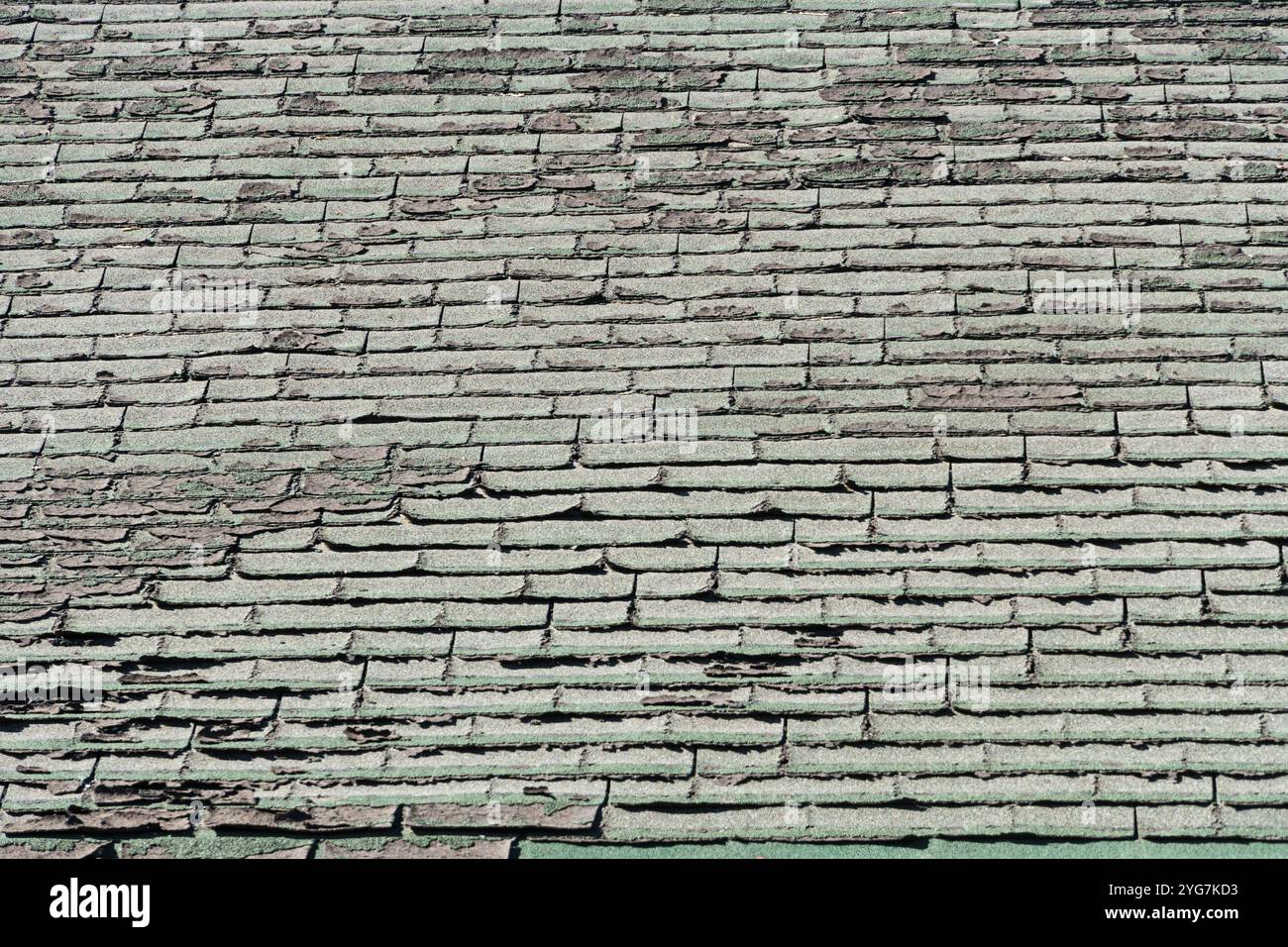 sun damaged composite shingle roof in bad need of repair Stock Photo ...