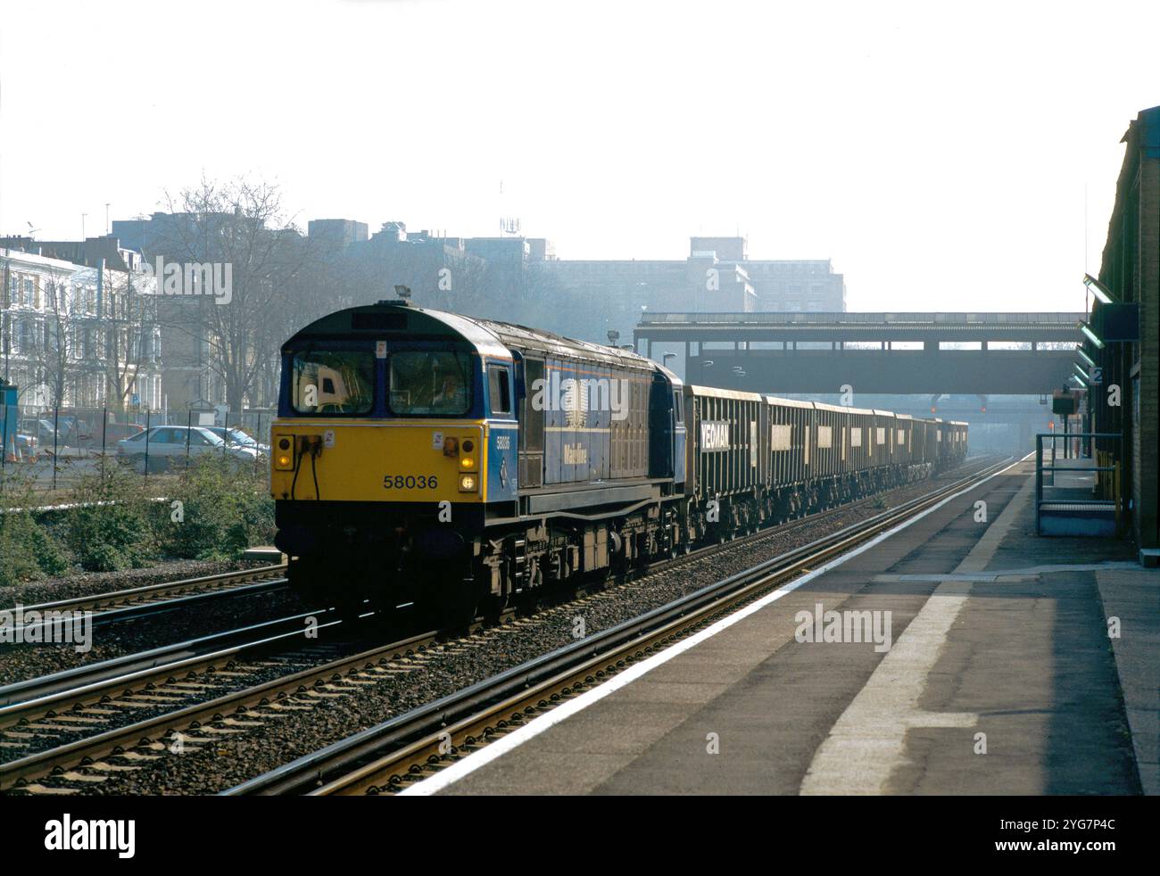 A Class 58 diesel locomotive number 58036 heads north through a misty ...