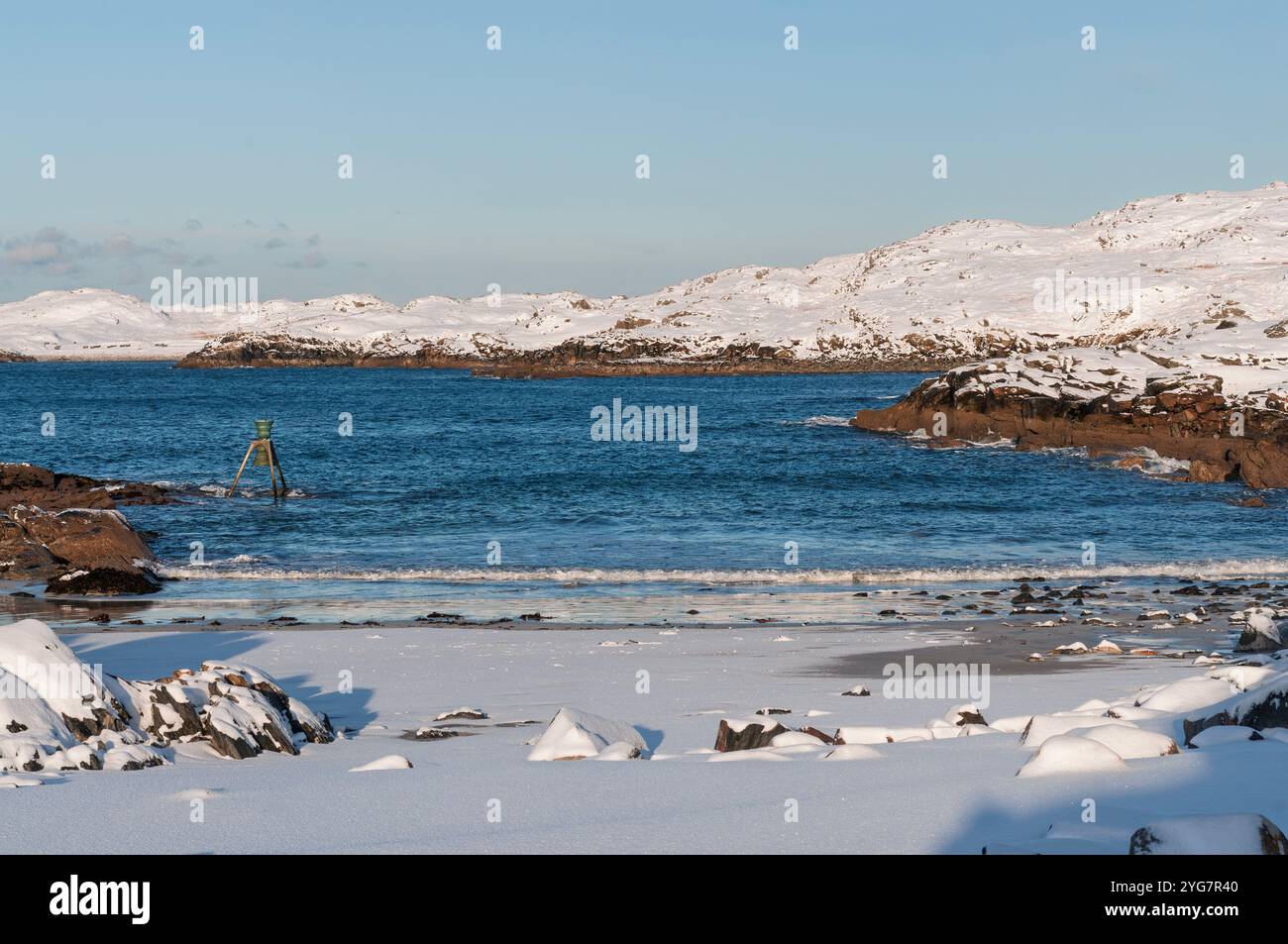 Snow on Bosta beach and bay on Great Bernera looking out to the islands ...