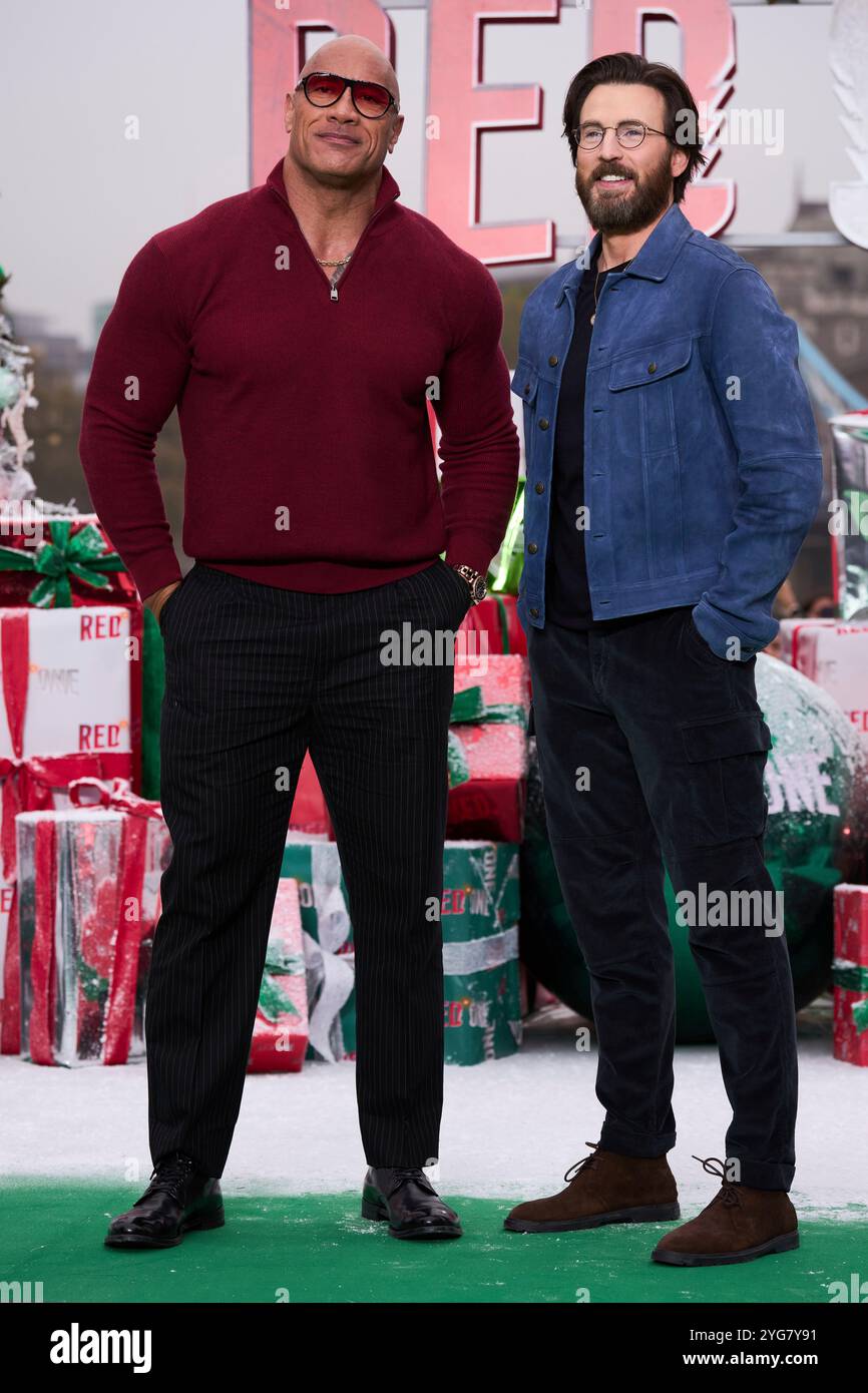 Dwayne Johnson, left, and Chris Evans pose for photographers upon ...