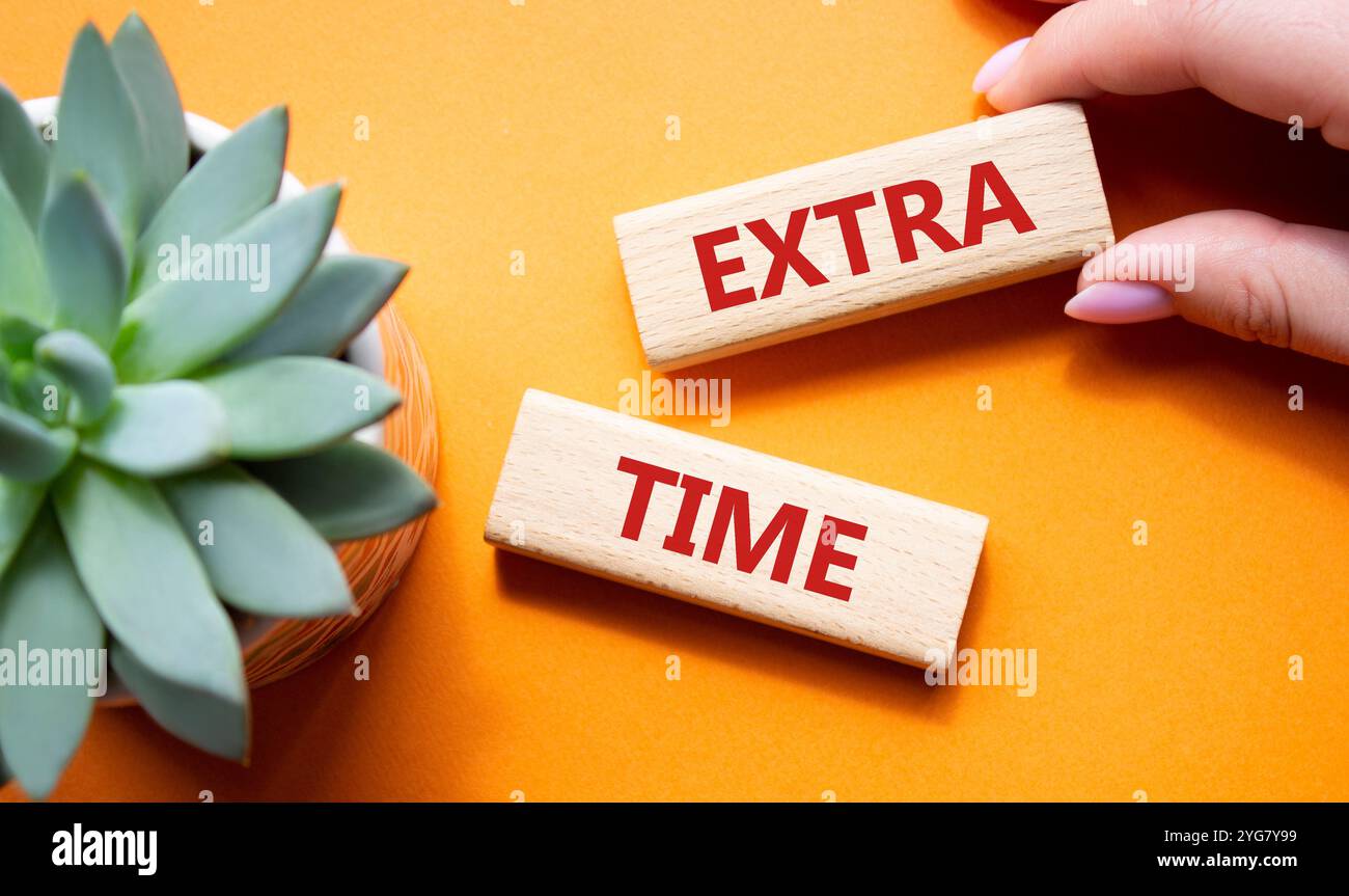 Extra time symbol. Concept word Extra time on wooden blocks. Beautiful ...