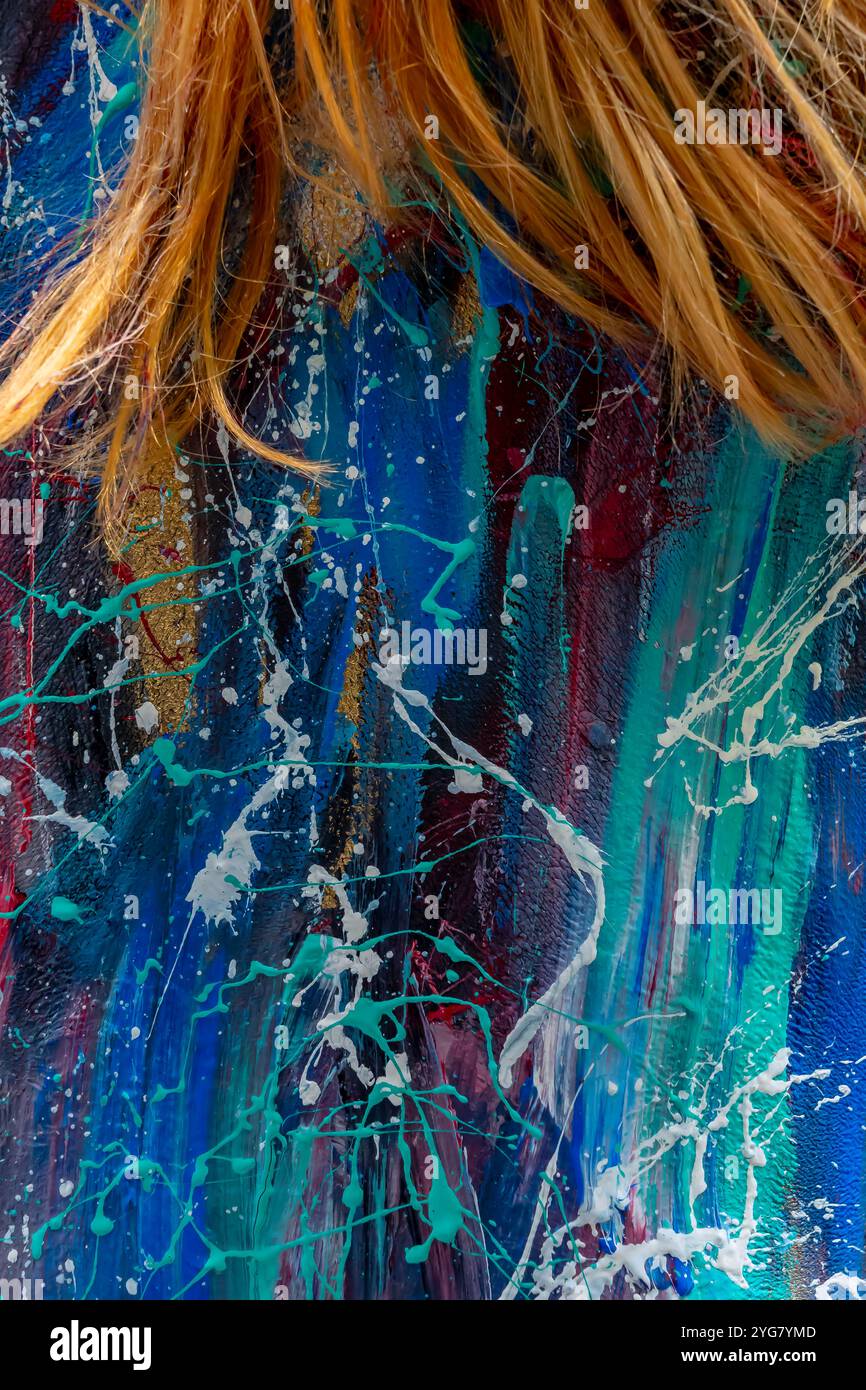 A model poses gracefully, her body adorned in vibrant body paint, with ...