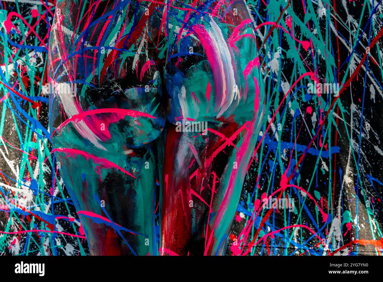 A model poses gracefully, her body adorned in vibrant body paint, with ...