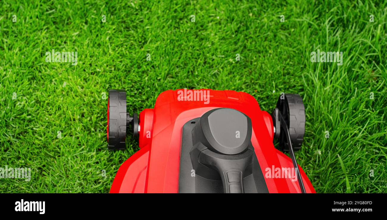 Red lawnmower on the lawn Stock Photo - Alamy
