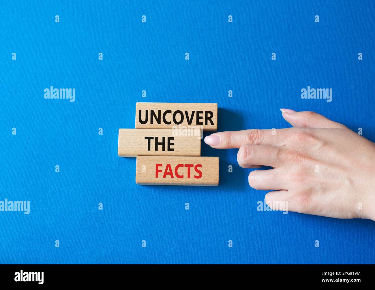 Uncover the Facts symbol. Concept word Uncover the Facts on wooden ...