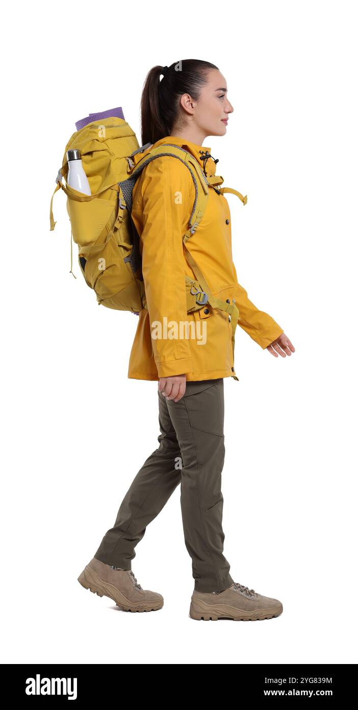 Young woman with backpack walking on white background. Active tourism ...