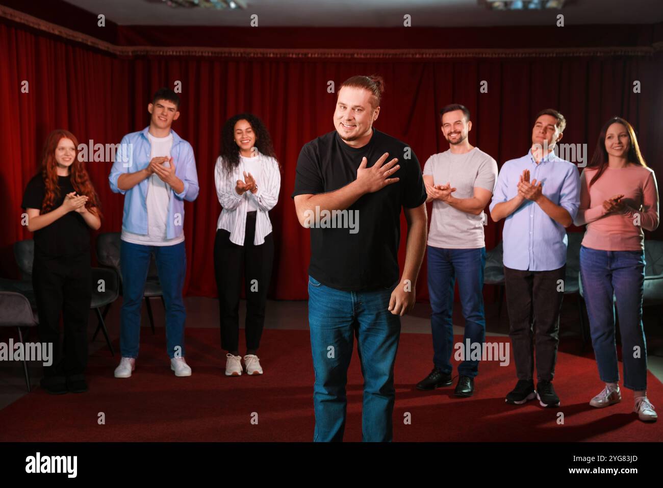 Professional actors bowing on stage in theatre Stock Photo - Alamy