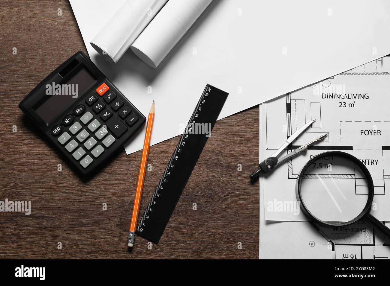 Different architectural drawings, pencil, magnifying glass, ruler ...