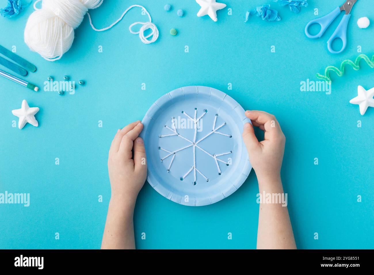 Snowflake made from wool threads on blue paper plate Christmas ideas ...