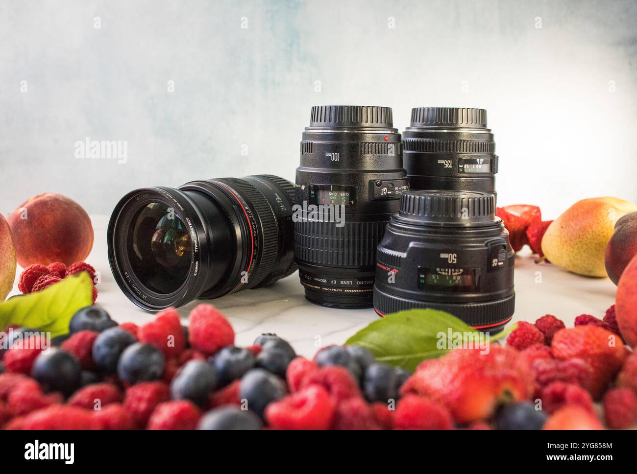 camera lens with fruit and food on white table Stock Photo - Alamy