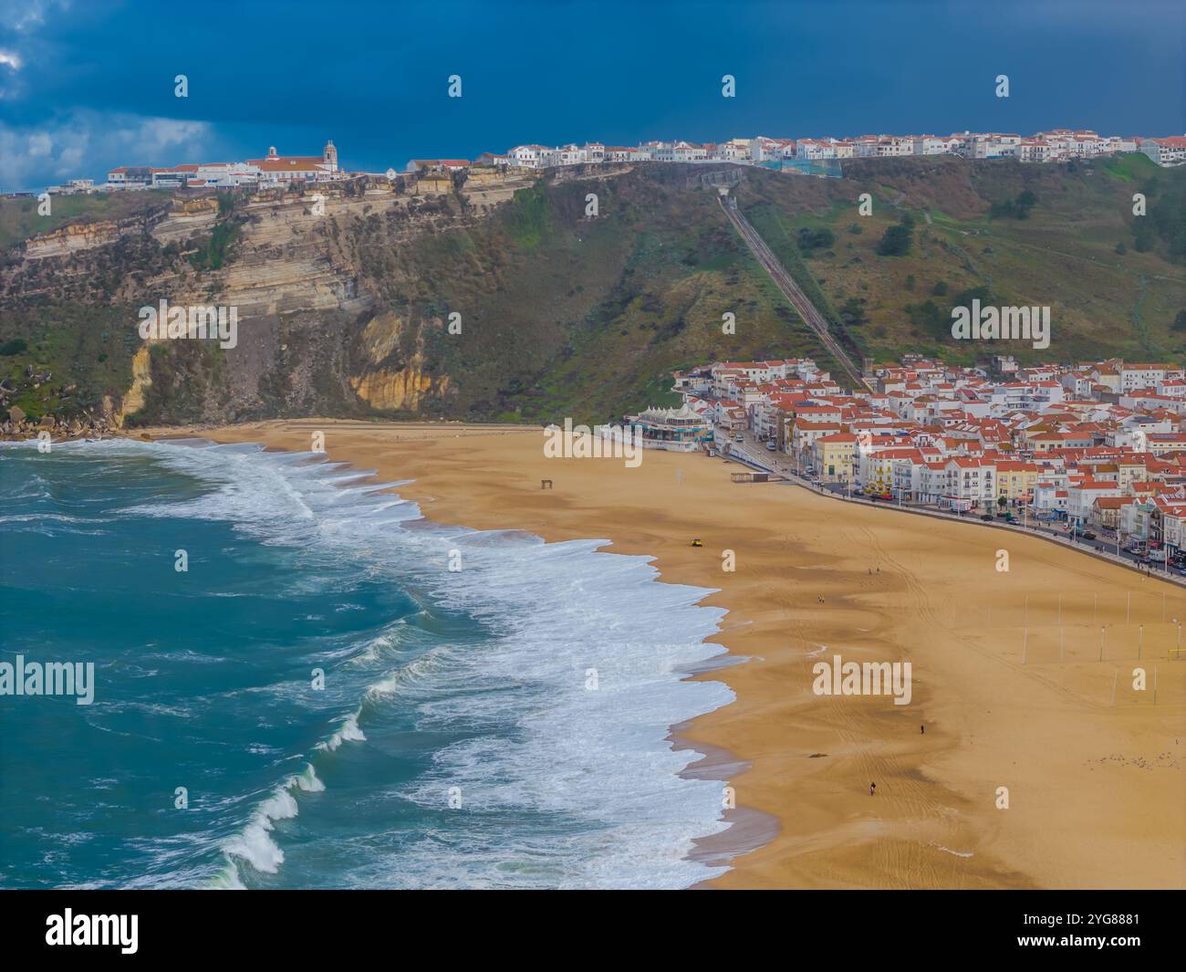 Aerial drone view of Portugal coastal town Nazare with lighthouse on a ...
