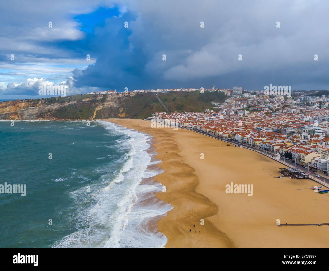 Aerial drone view of Portugal coastal town Nazare with lighthouse on a ...