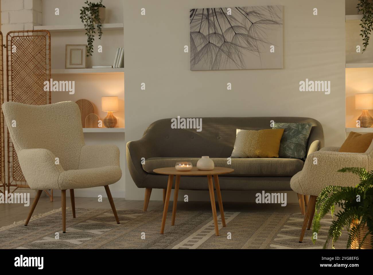 Beautiful armchairs, sofa and coffee table in living room. Interior ...