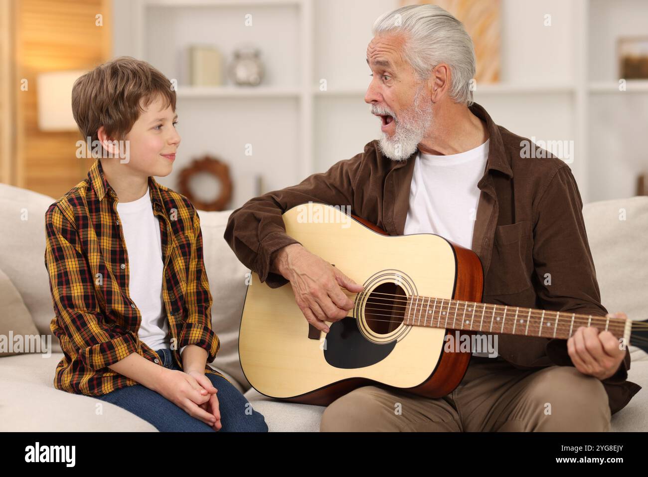 Grandpa teaching grandson play hi-res stock photography and images - Alamy