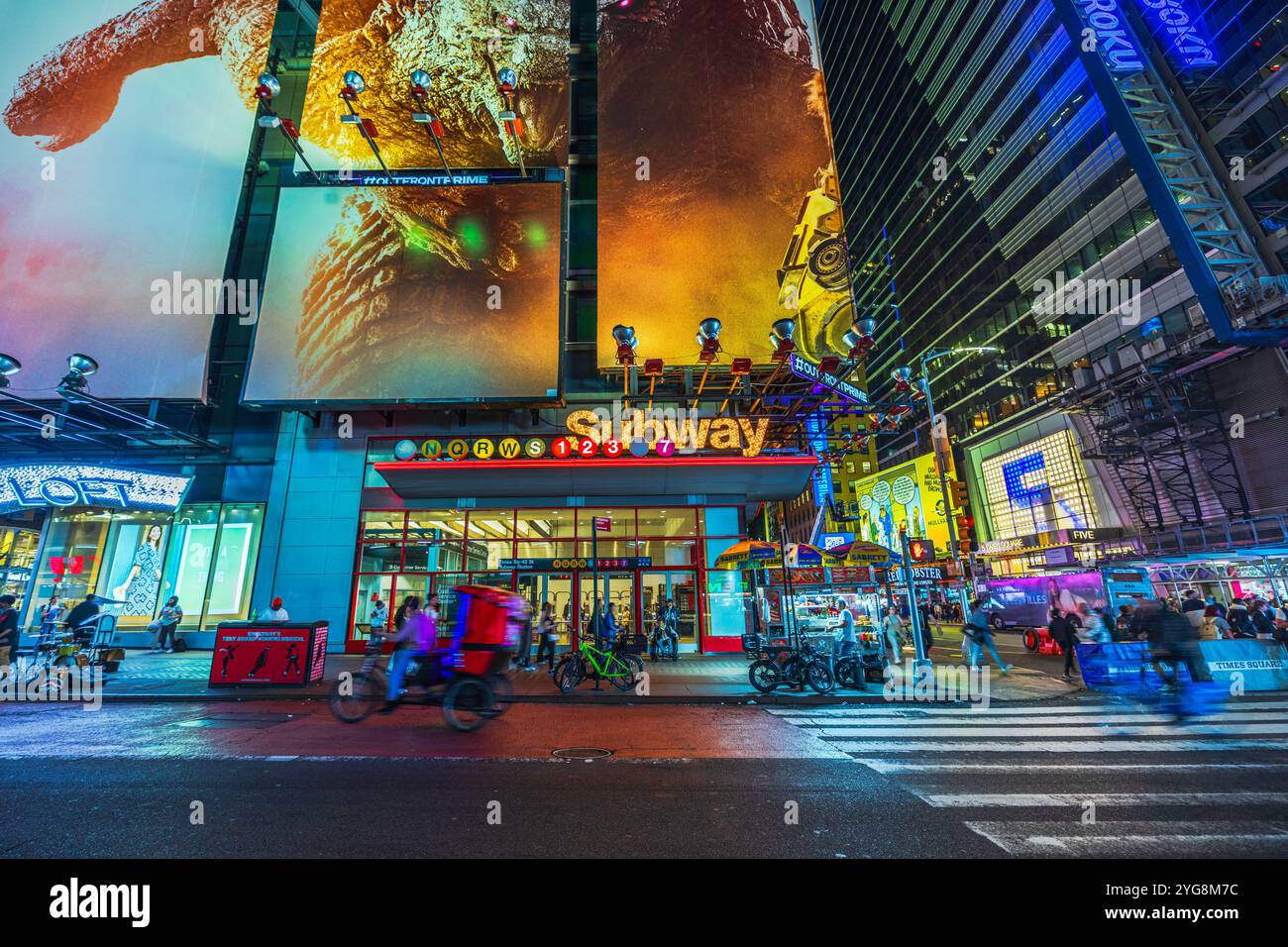 Times Square subway entrance with neon lights, advertisements, and ...