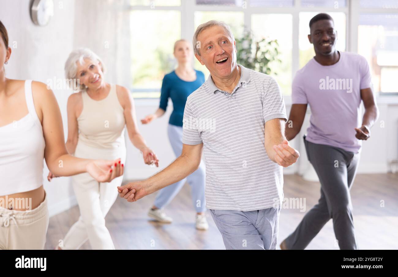 Group of multiethnic mature people dancing modern dance Stock Photo - Alamy