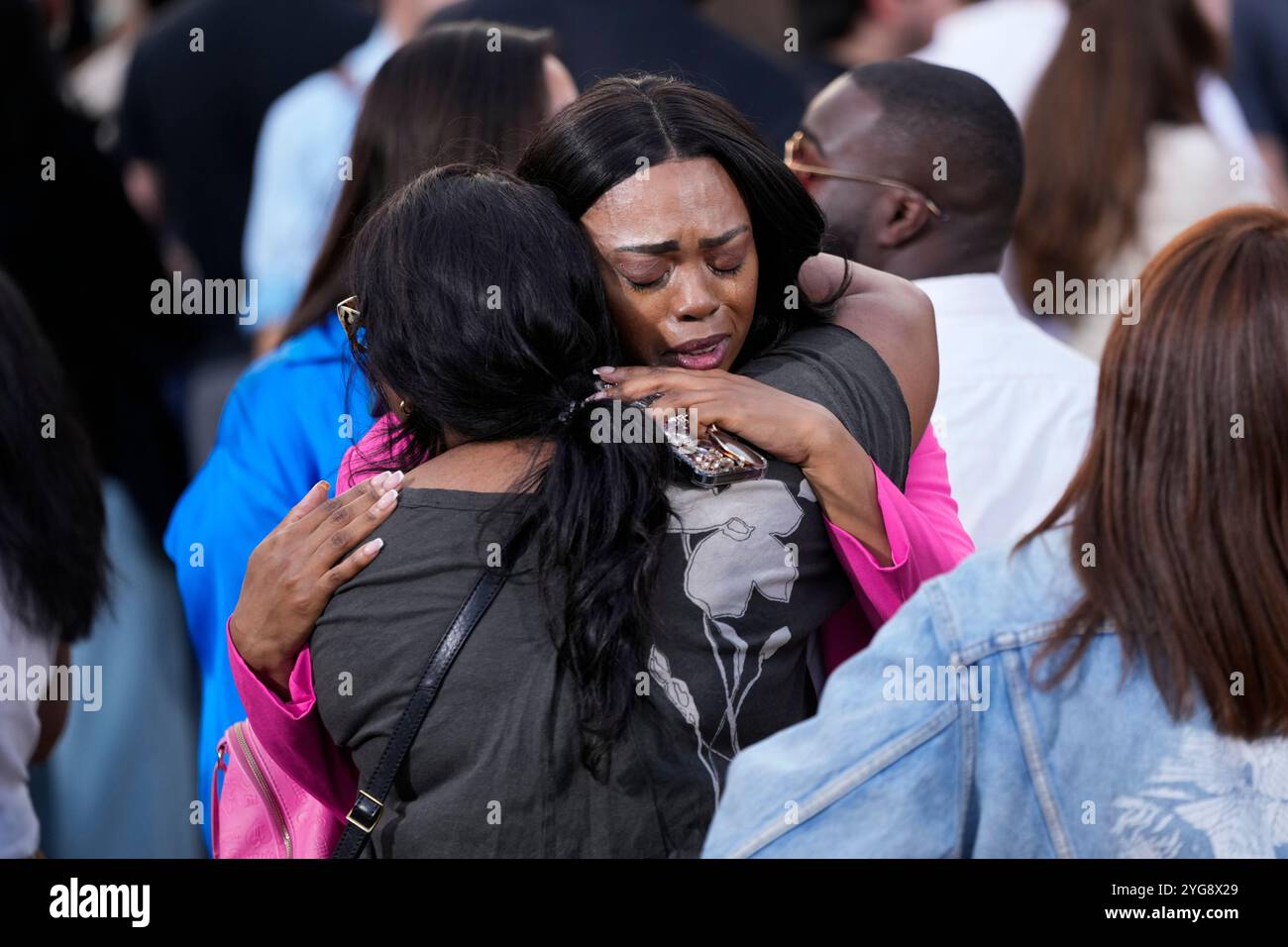 Attendees hug after Vice President Kamala Harris delivers a concession ...
