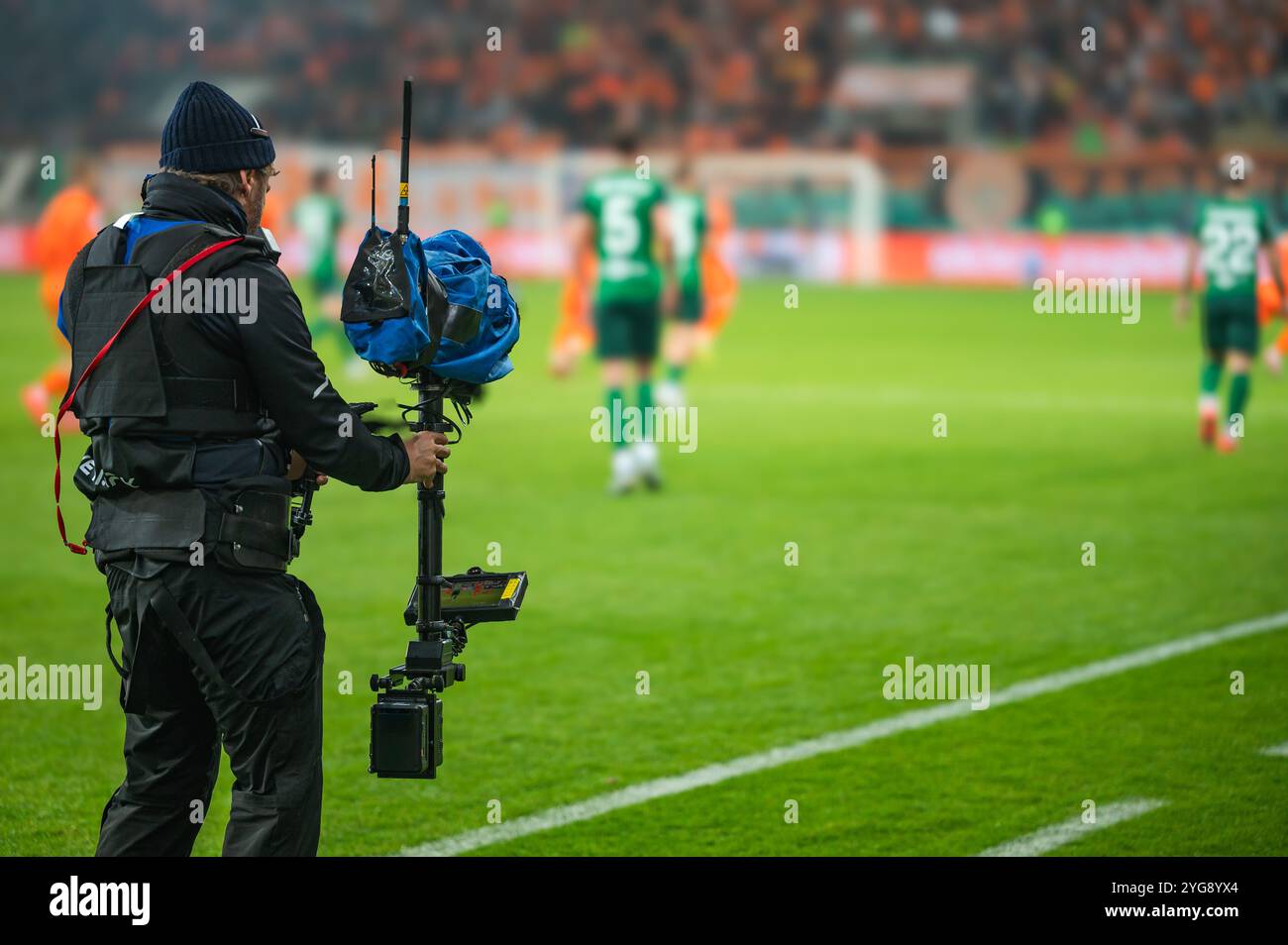 Cameraman behind playing field during soccer match Stock Photo - Alamy