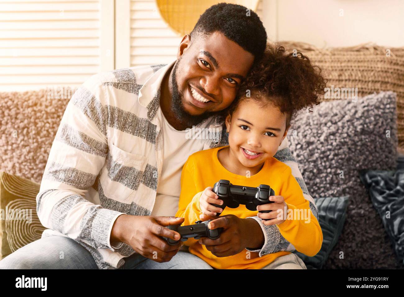 African american family gamers playing on console Stock Photo - Alamy