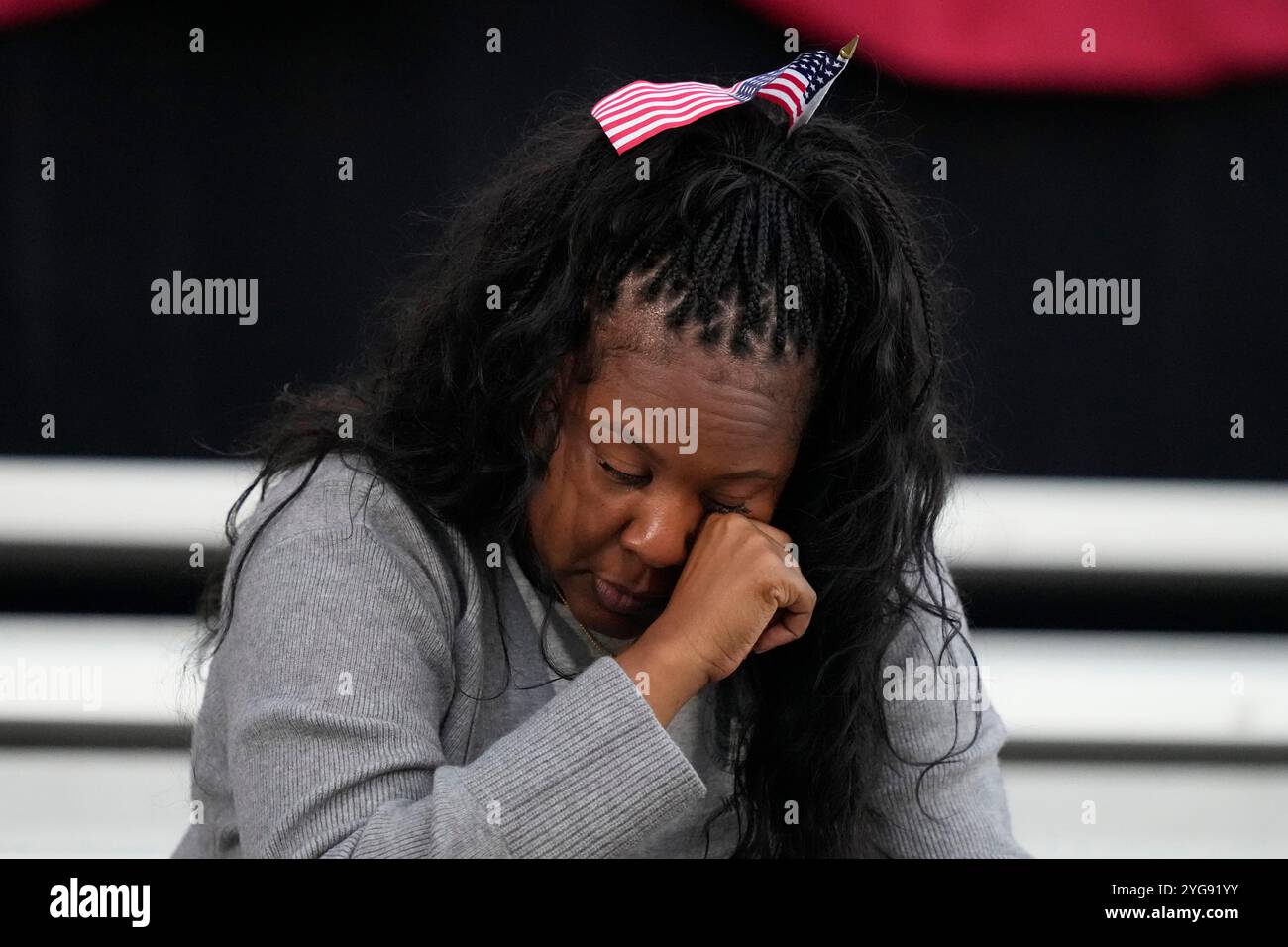 Chioma Tait, a PhD student at Howard University, wipes away a tear ...