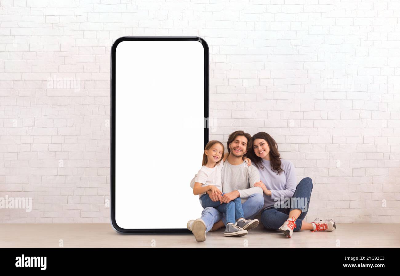 Family poses together in front of a blank screen in a modern indoor ...