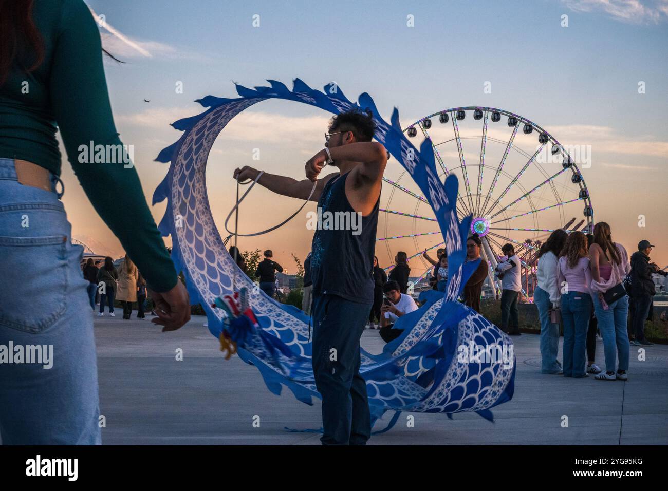 Seattle, USA. 13th Oct 2024. Chinese Dance Dragon Ribbon at sunset from ...