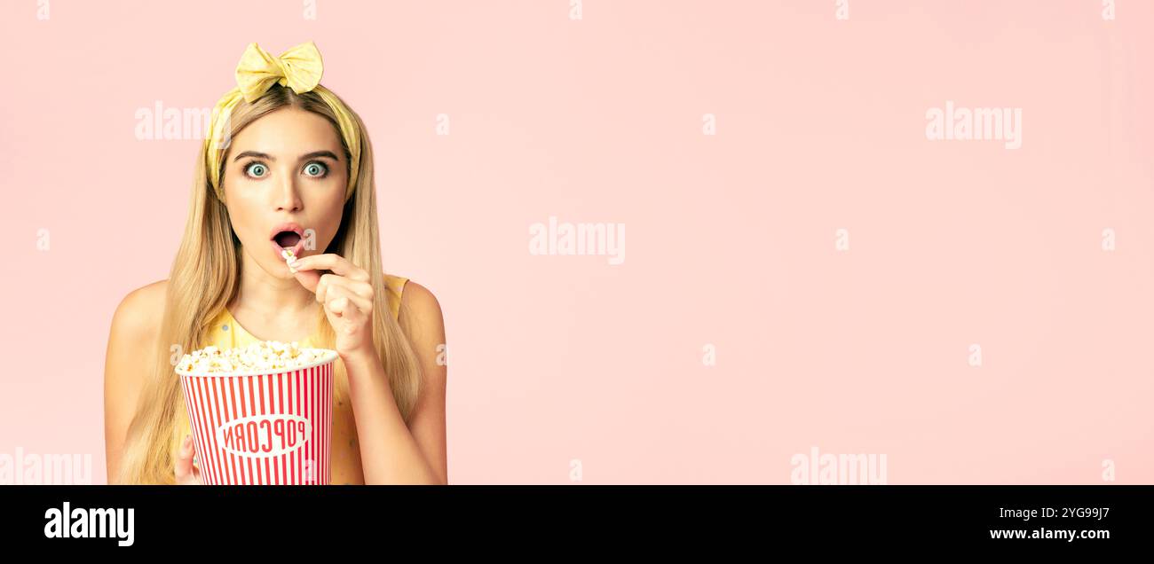 Shocked girl watching movie with pop corn Stock Photo - Alamy