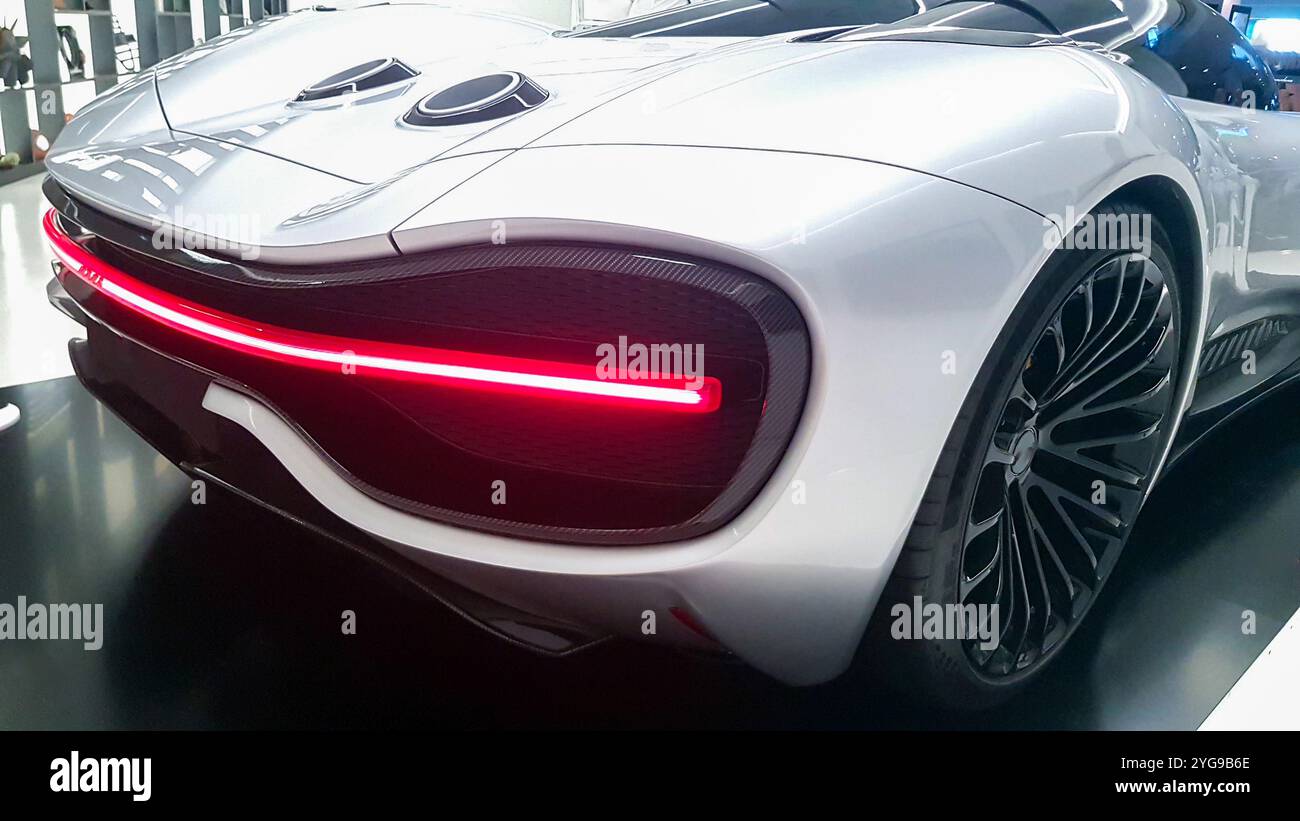 Side Rear view with red braking lights of exposed silver luxury sports ...