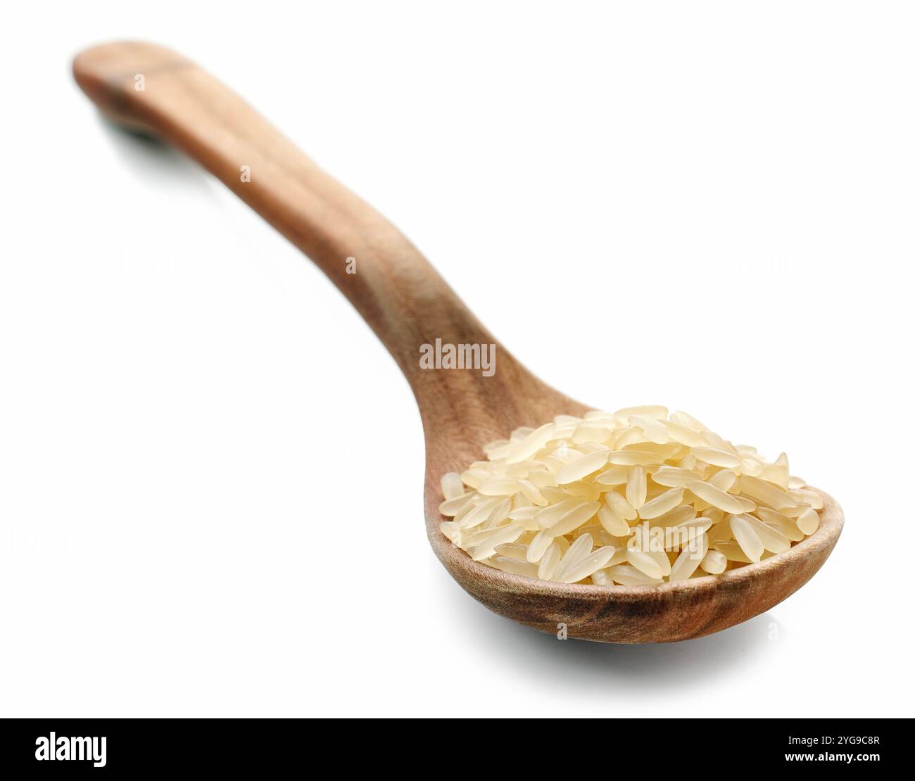 raw rice in wooden spoon isolated on white background Stock Photo - Alamy