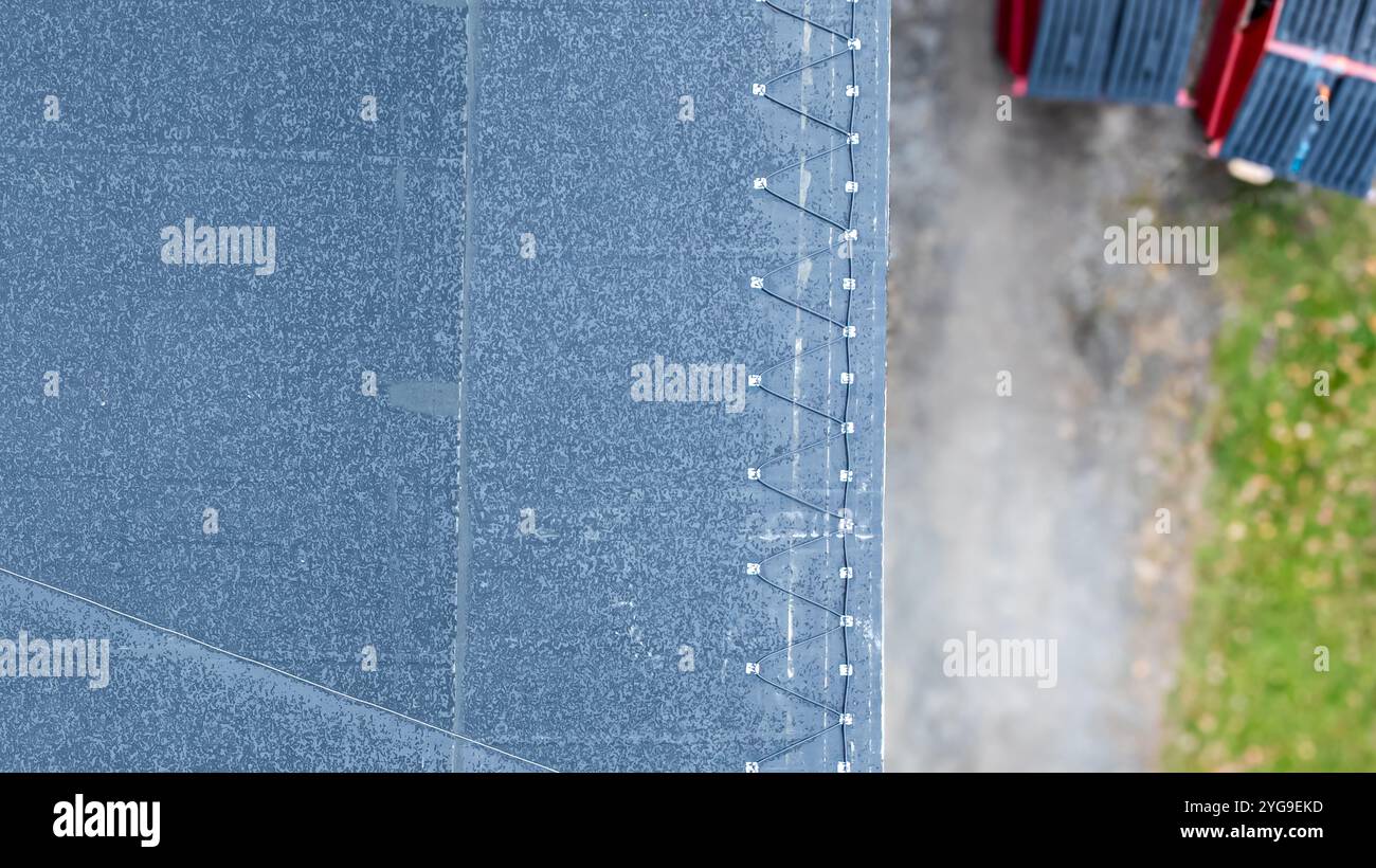 Electric roof heating system. Wire is fixed to a new EPDM commercial ...