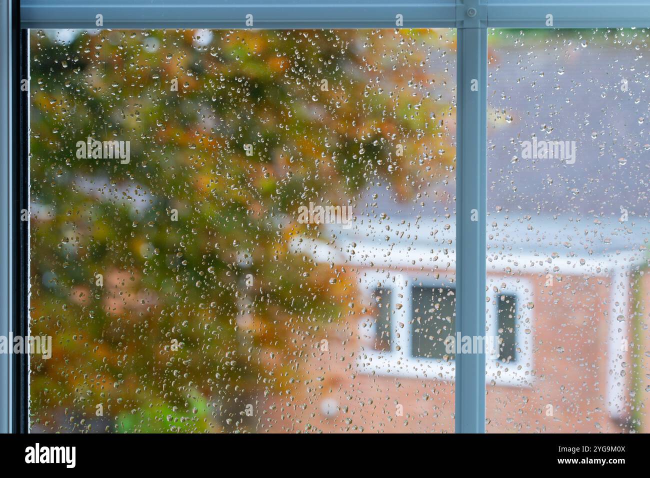 Raindrops hitting a window on a rainy autumn day in Basingstoke with ...