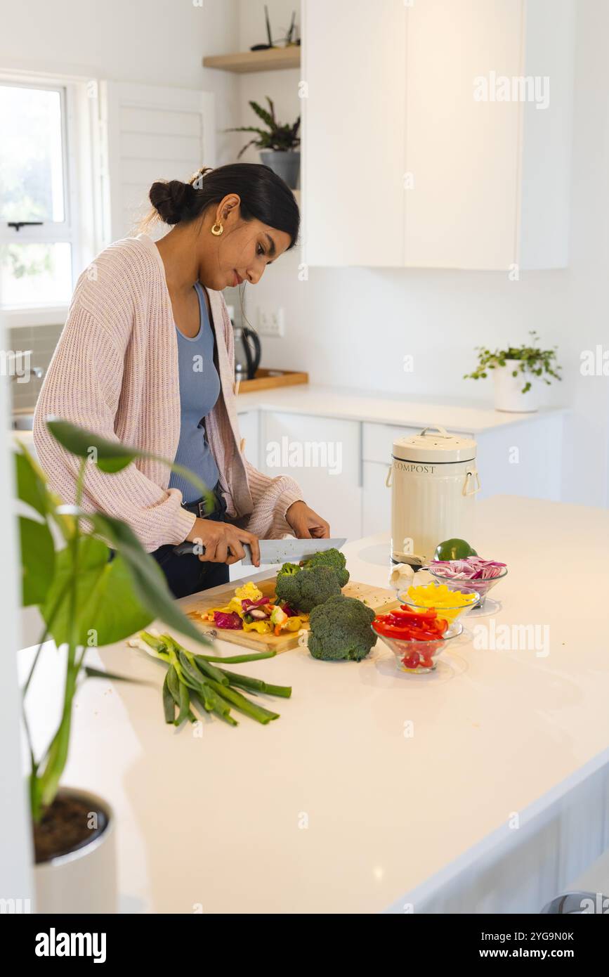 Preparing fresh vegetables, Asian woman focusing on healthy cooking in ...