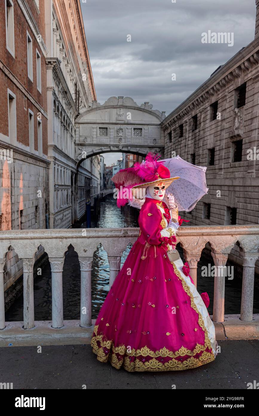 Italy, Venice. Model in Carnival costume with The Bridge of Sighs in ...