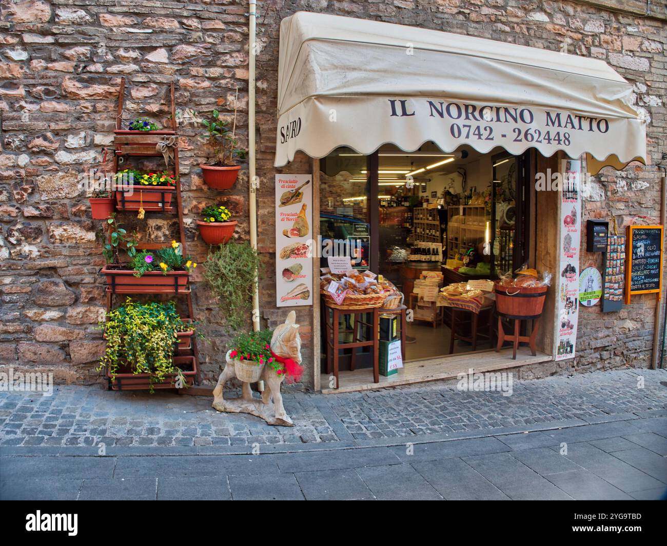 Italy, Umbria, Spello. Storefront along the street. (Editorial Use Only ...