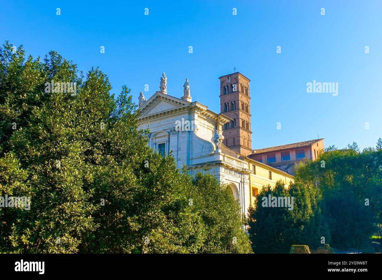 Santa Francesca Romana Basilica through the lush greenery, Roman Forum ...