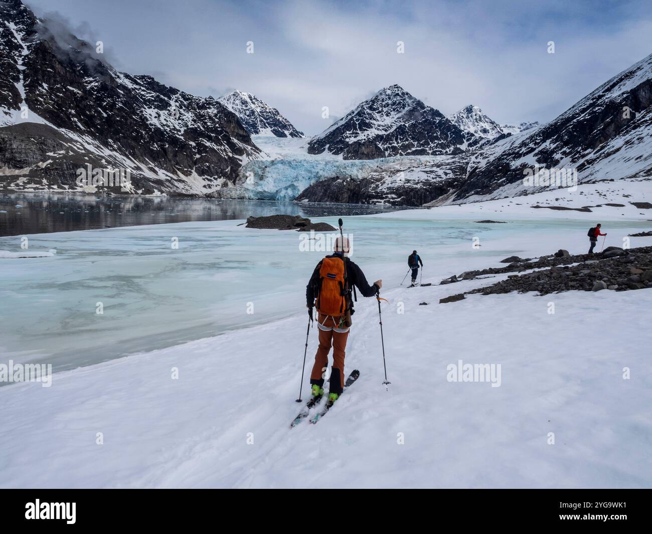 Svalbard, Norway. Guide and skiers explore ice filled bay. (Editorial ...