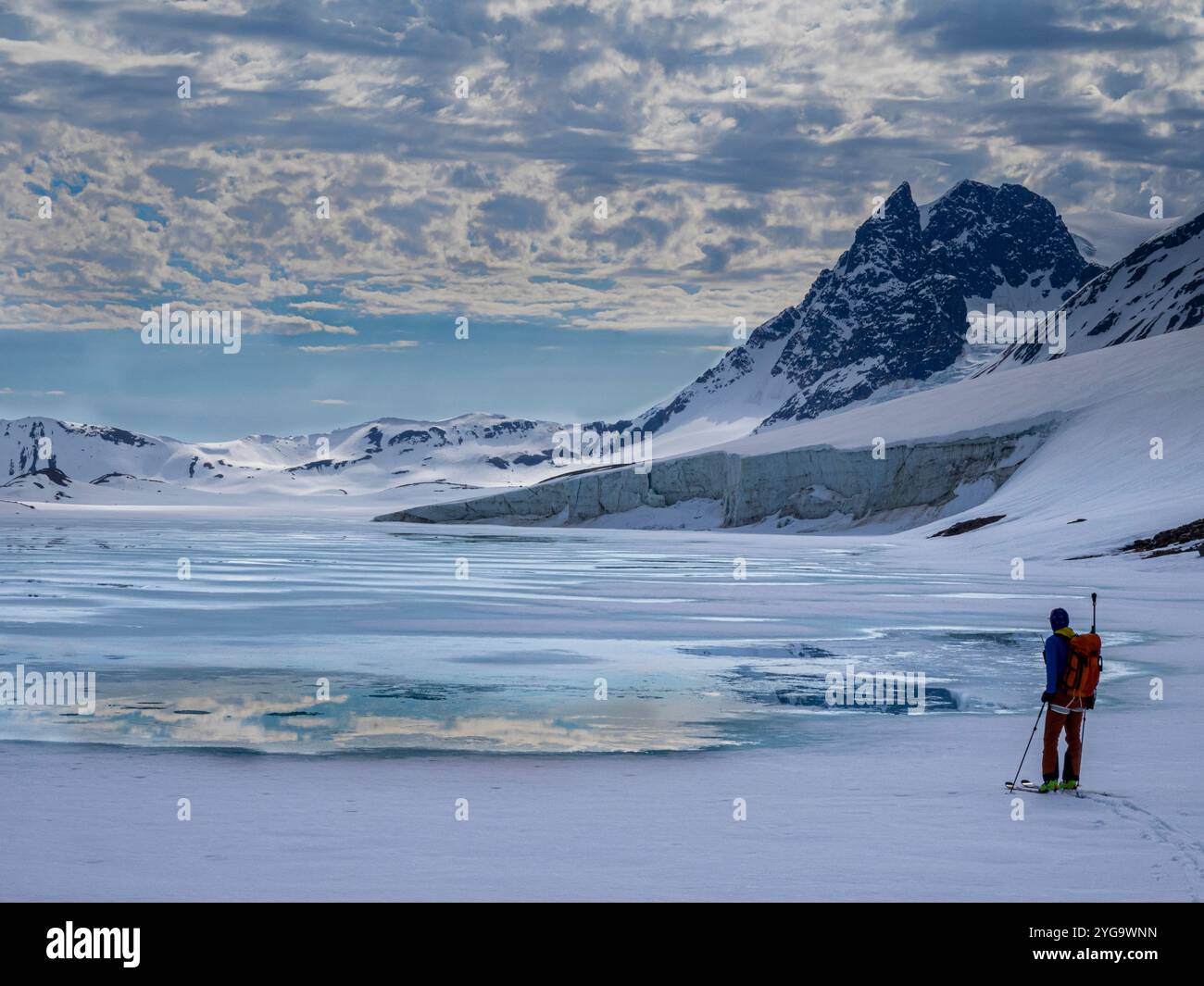 Svalbard, Norway. Guide enjoys the scenery, but keeps an eye out for ...