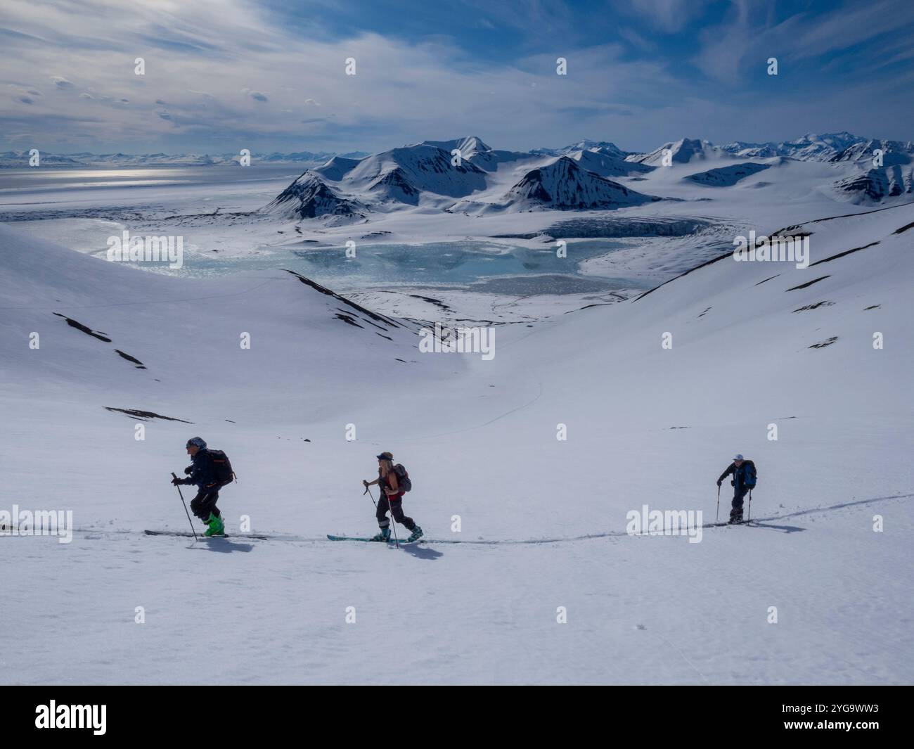 Svalbard, Norway. Three skiers traverse a scenic landscape. (MR Stock ...