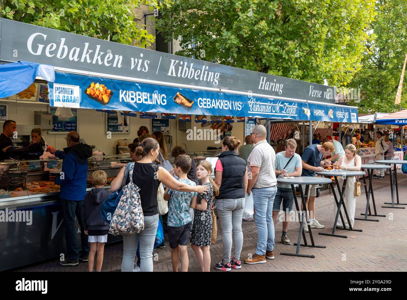 Seafood market stall in Hengelo, customers queue to order kibbeling and ...