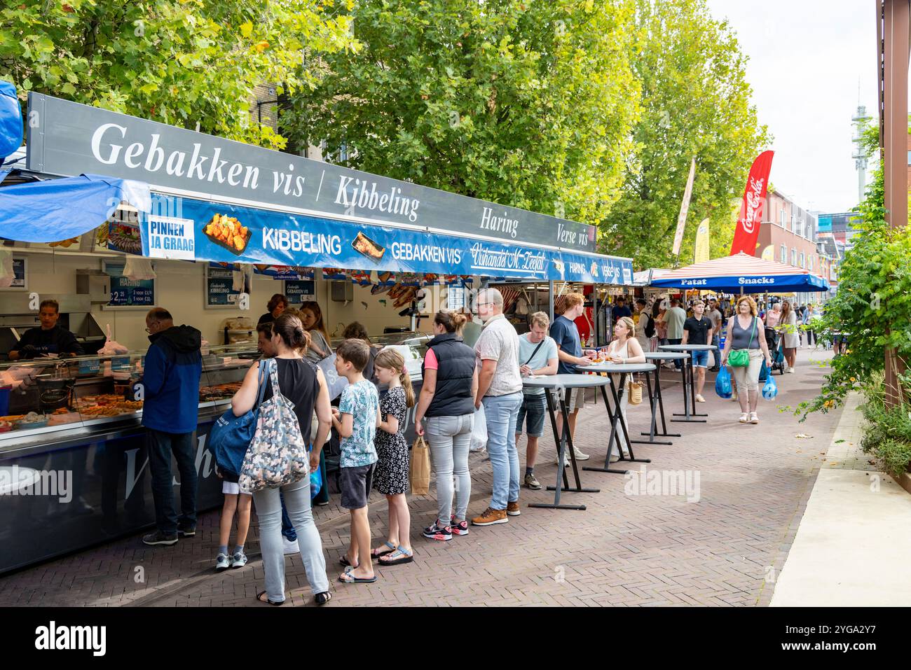 Seafood market stall in Hengelo, customers queue to order kibbeling and ...