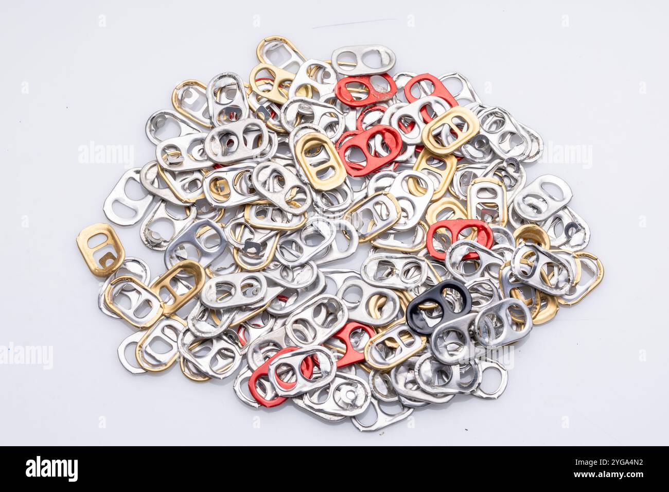 A pile of assorted aluminum can pull tabs in silver, gold, red and ...